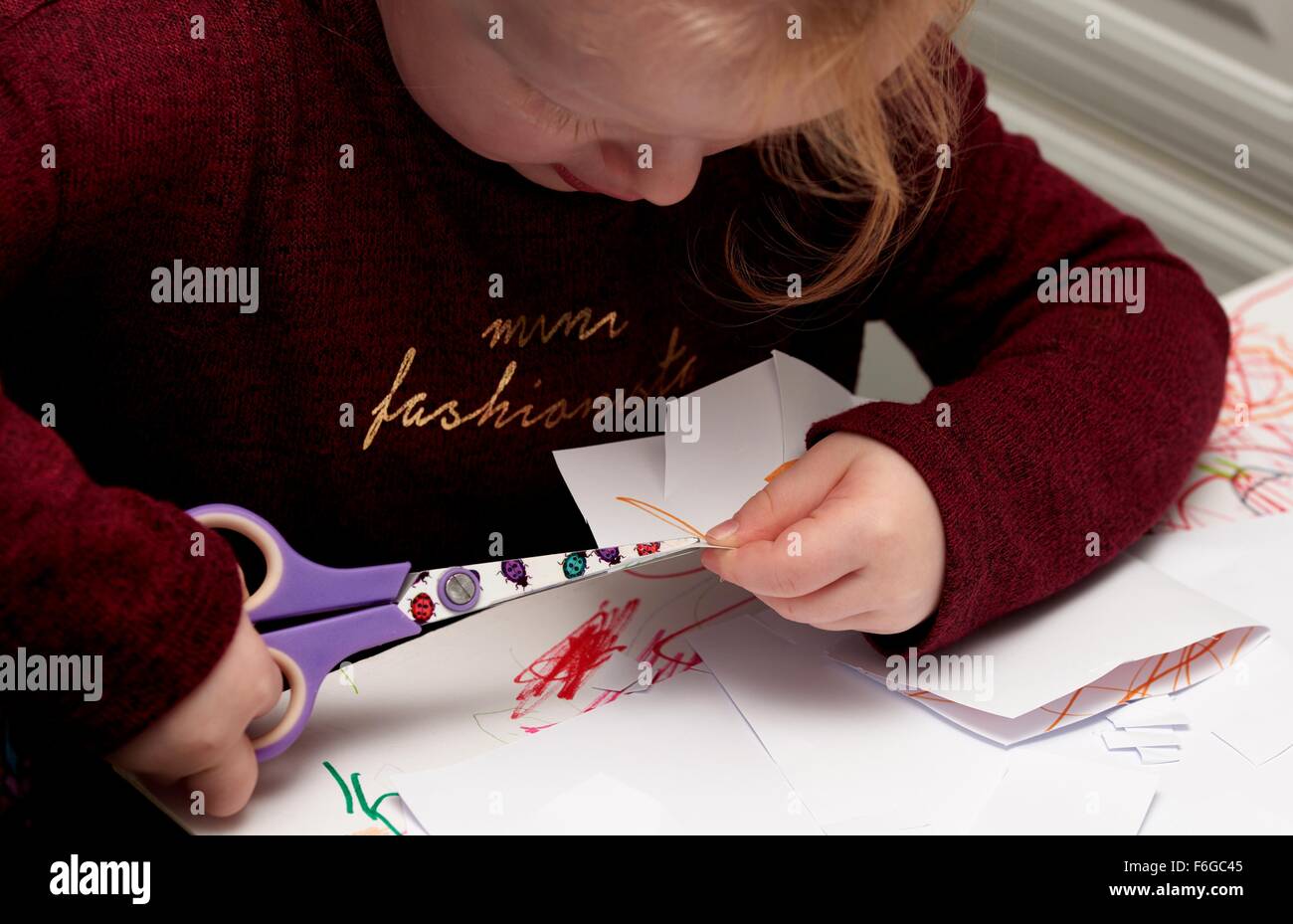 A 3 year old girl learning to use scissors Stock Photo - Alamy
