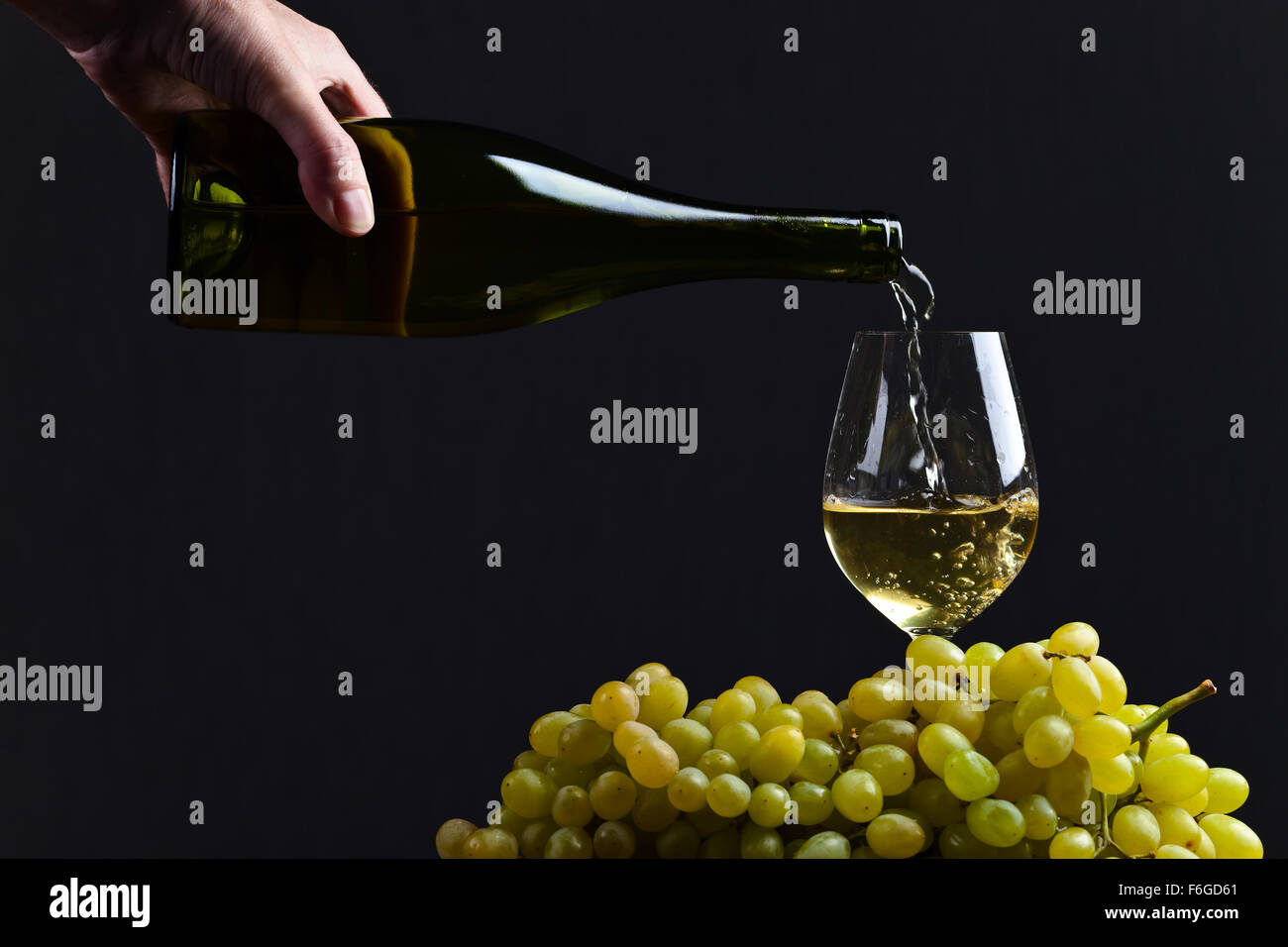 White wine being poured into a wineglass Stock Photo - Alamy