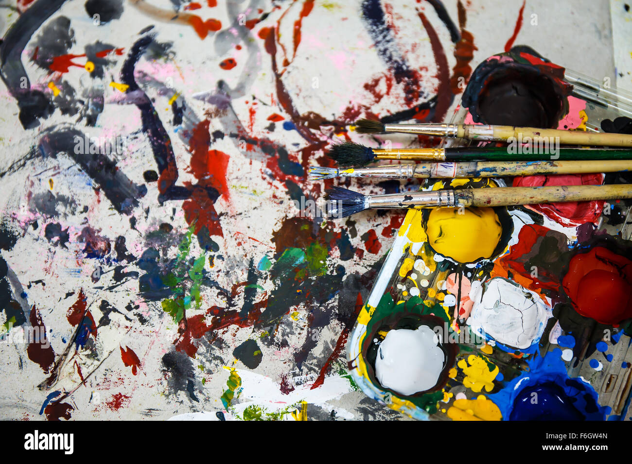 Paints and brushes on table Stock Photo - Alamy