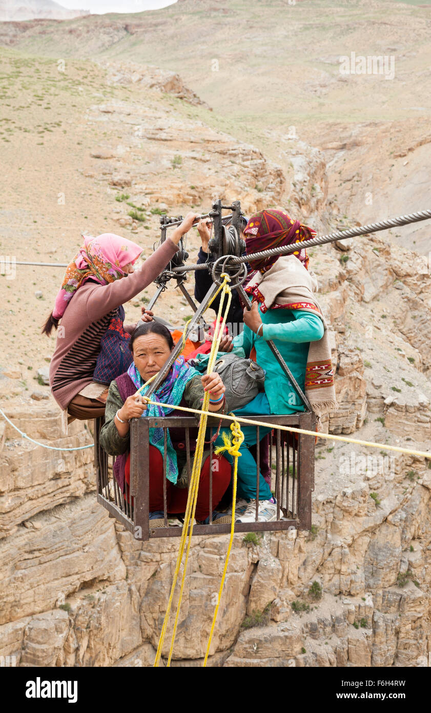 Women make hazardous crossing of Himalayan gorge using improvised cable ...