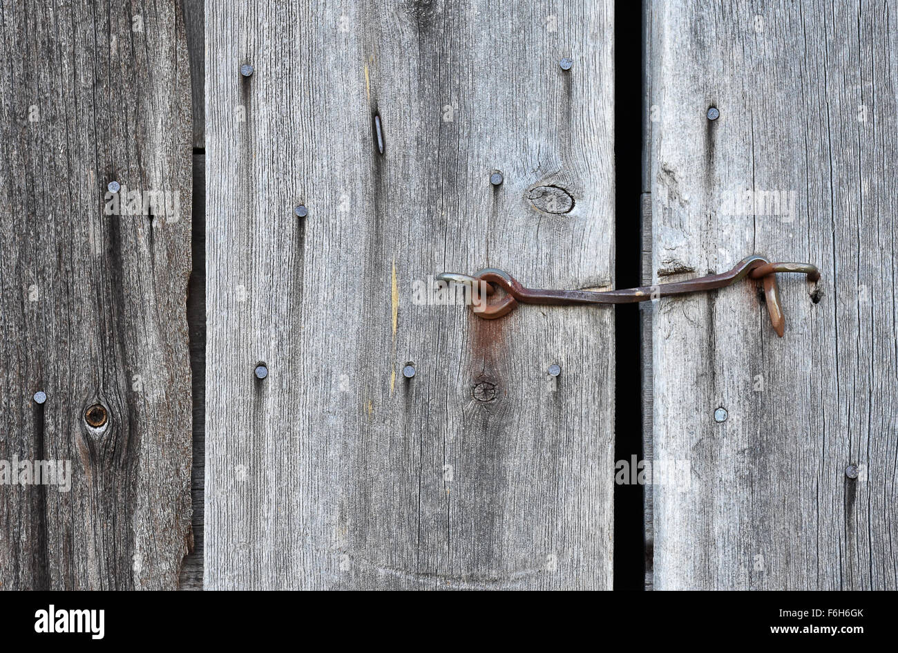 Close up of a rusty old hook on weathered barn door Stock Photo - Alamy