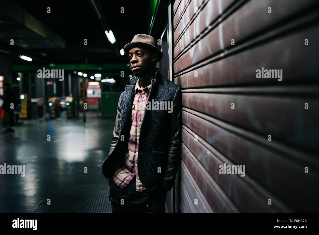 Knee figure of young handsome afro black man posing leaning against a ...