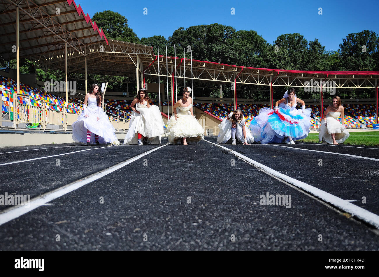 funny brides on the treadmill outdoors on the stadium Stock Photo - Alamy