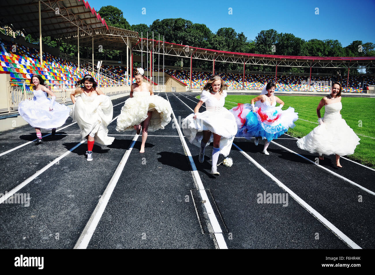 funny brides on the treadmill outdoors on the stadium Stock Photo - Alamy