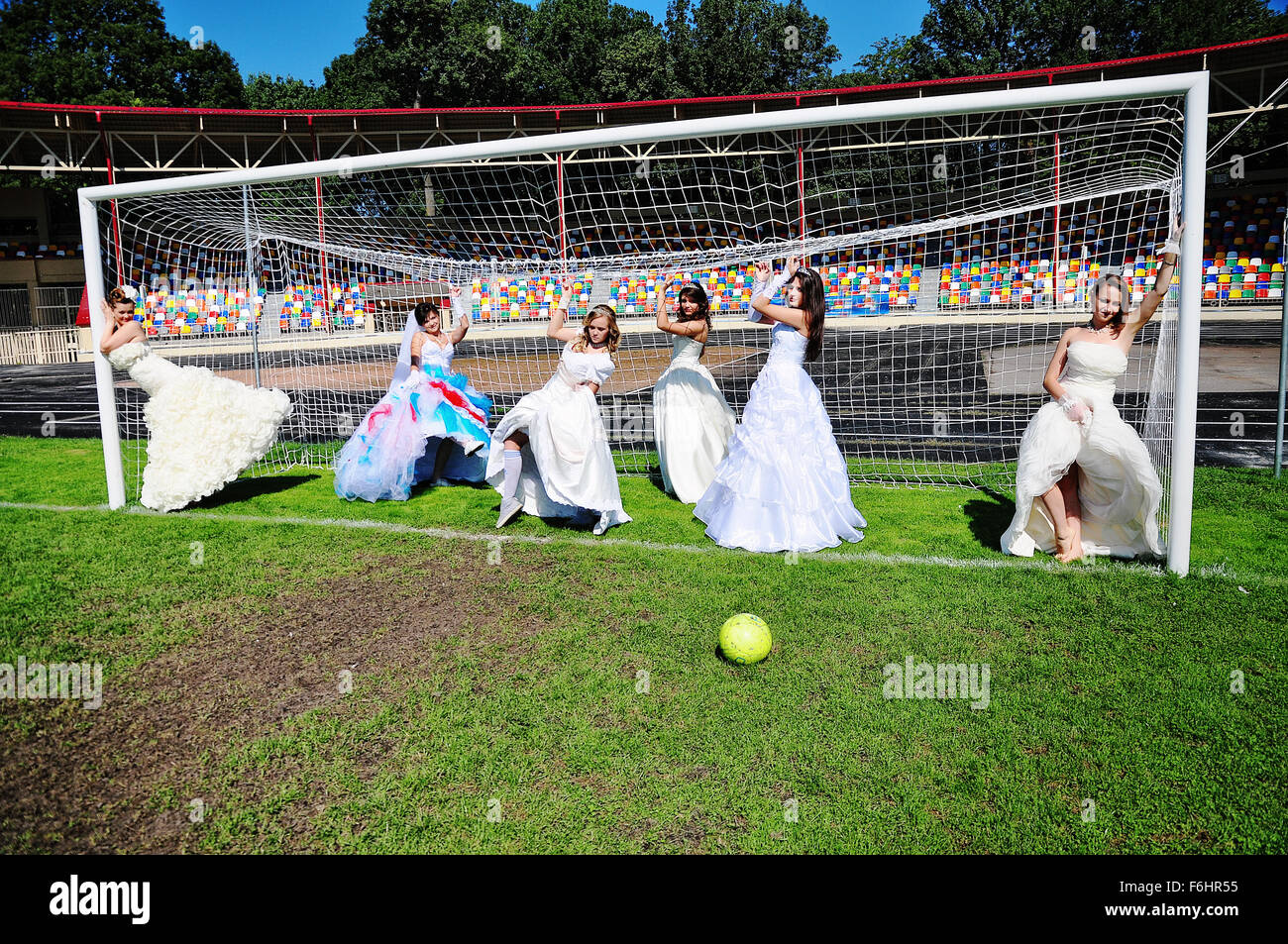 funny brides at the football field Stock Photo - Alamy