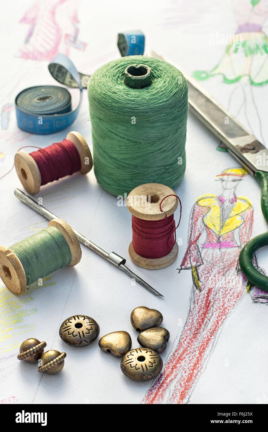 Spools of thread for sewing on the background of the sketch clothing ...