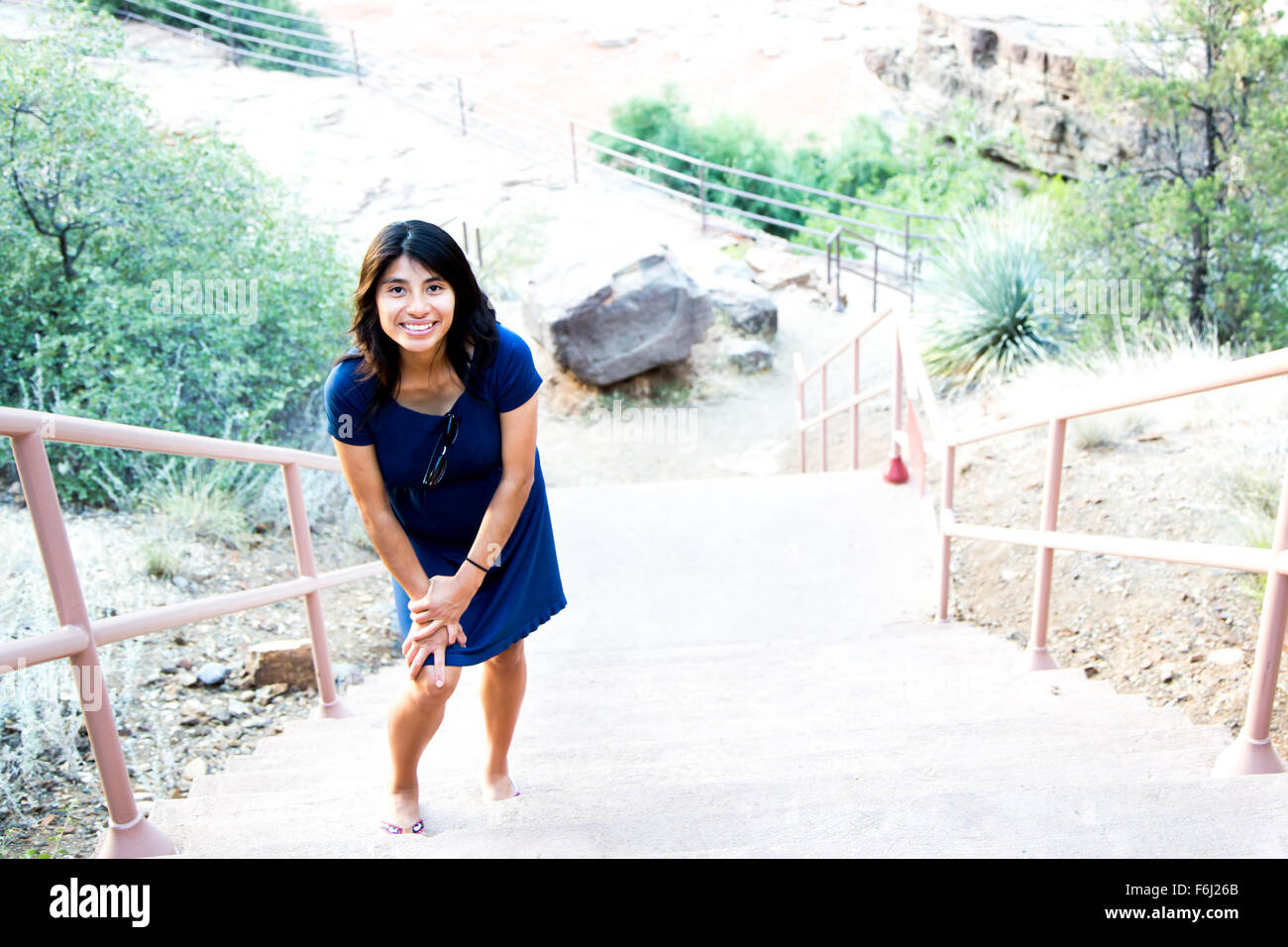 Woman walking up stairs and posing Stock Photo - Alamy