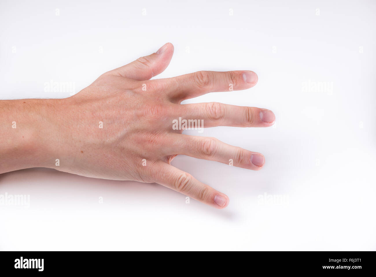 A hand with open fingers grabbing emptyness on a white background Stock ...