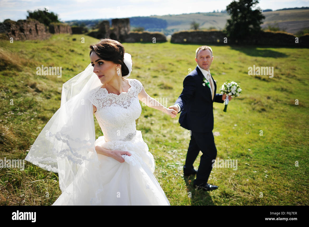 lovely wedding couple holding hands Stock Photo - Alamy