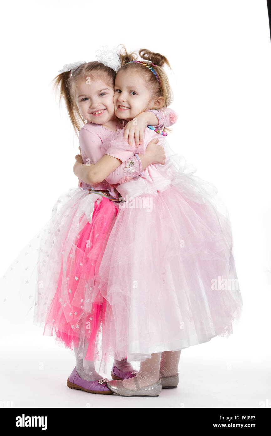 Two little girls - best friends on white Stock Photo - Alamy