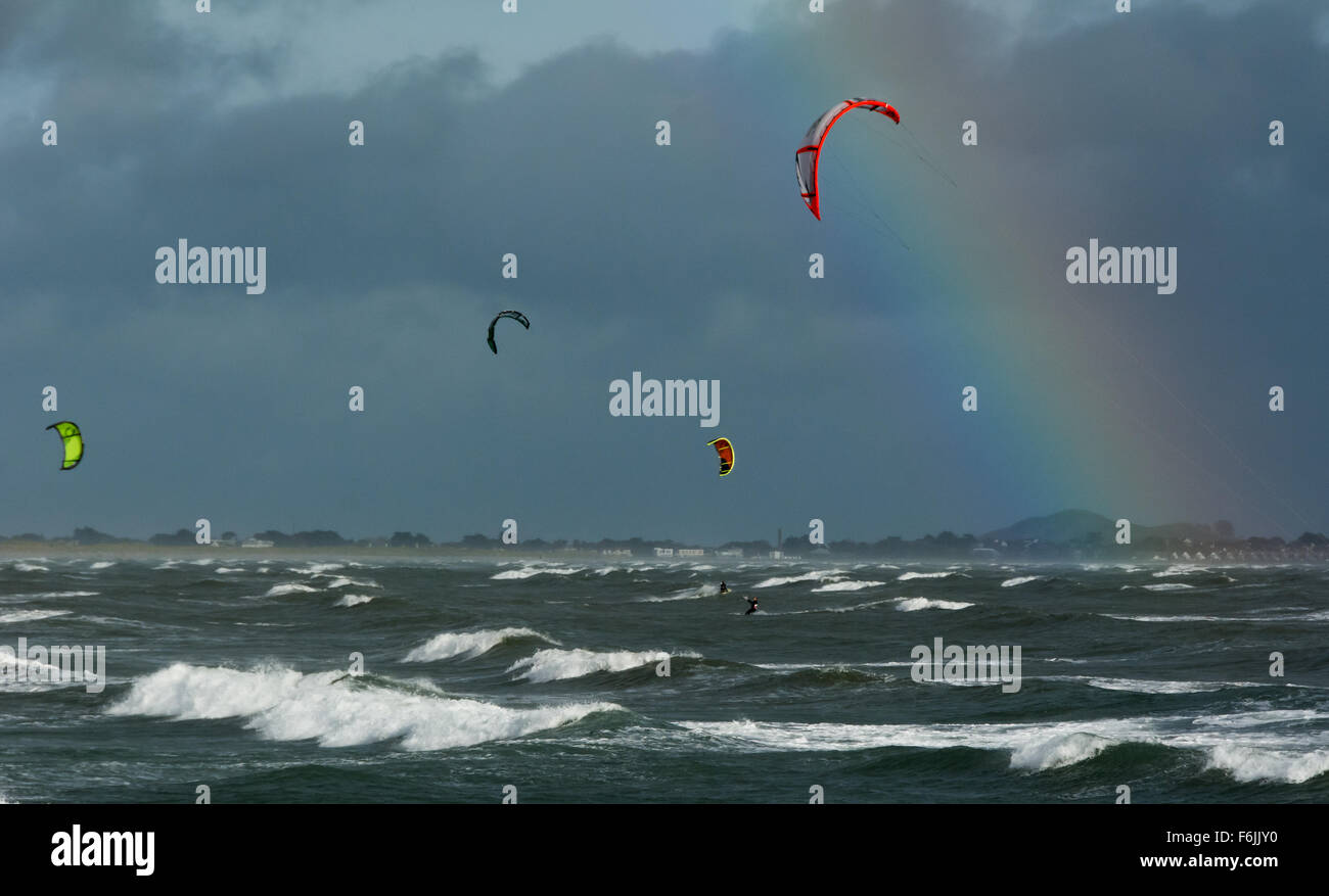 Para surfing off Bull Island,Dublin, in the Irish sea with a rainbow in ...