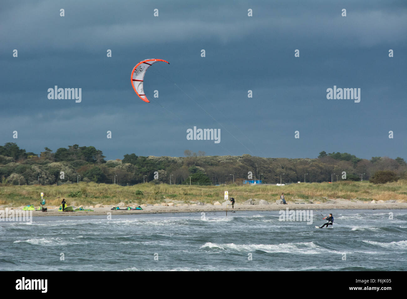 Para surfing off Bull Island,Dublin, in the Irish sea with a rainbow in ...