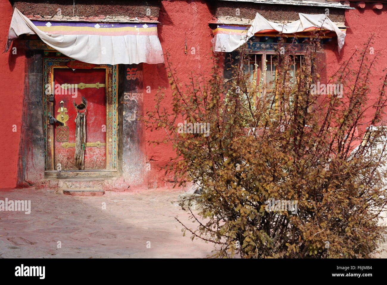 Buddhist shrine with red walls and fabric canopy on red door-the 1073 ...
