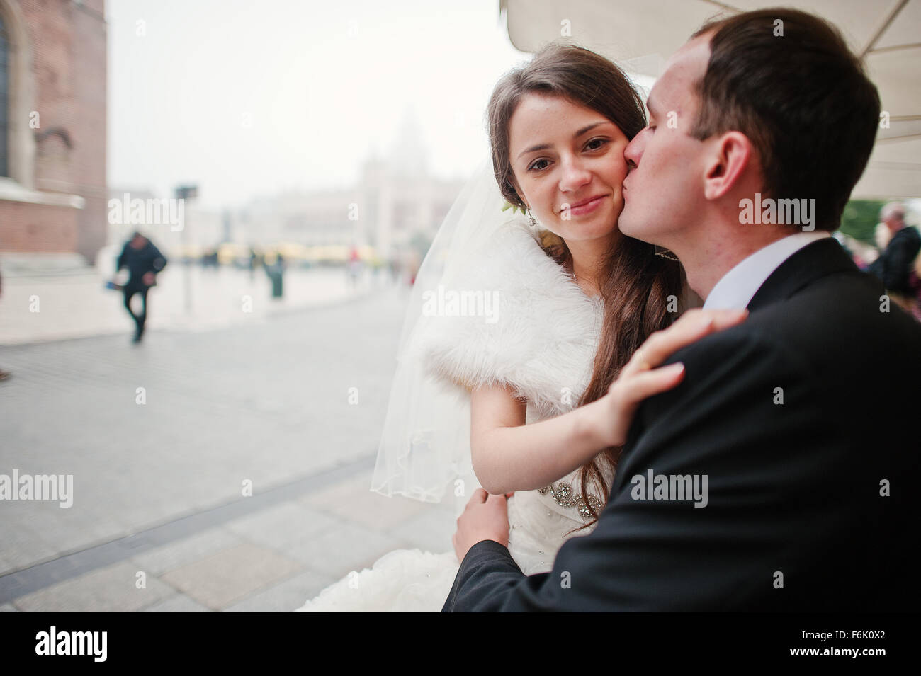 Young elegant and hearty wedding couple in love on streets of Krakow ...