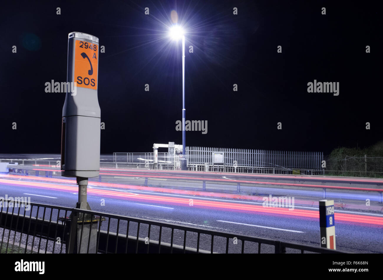 Emergency telephone at night by side of M48 motorway near the Severn ...