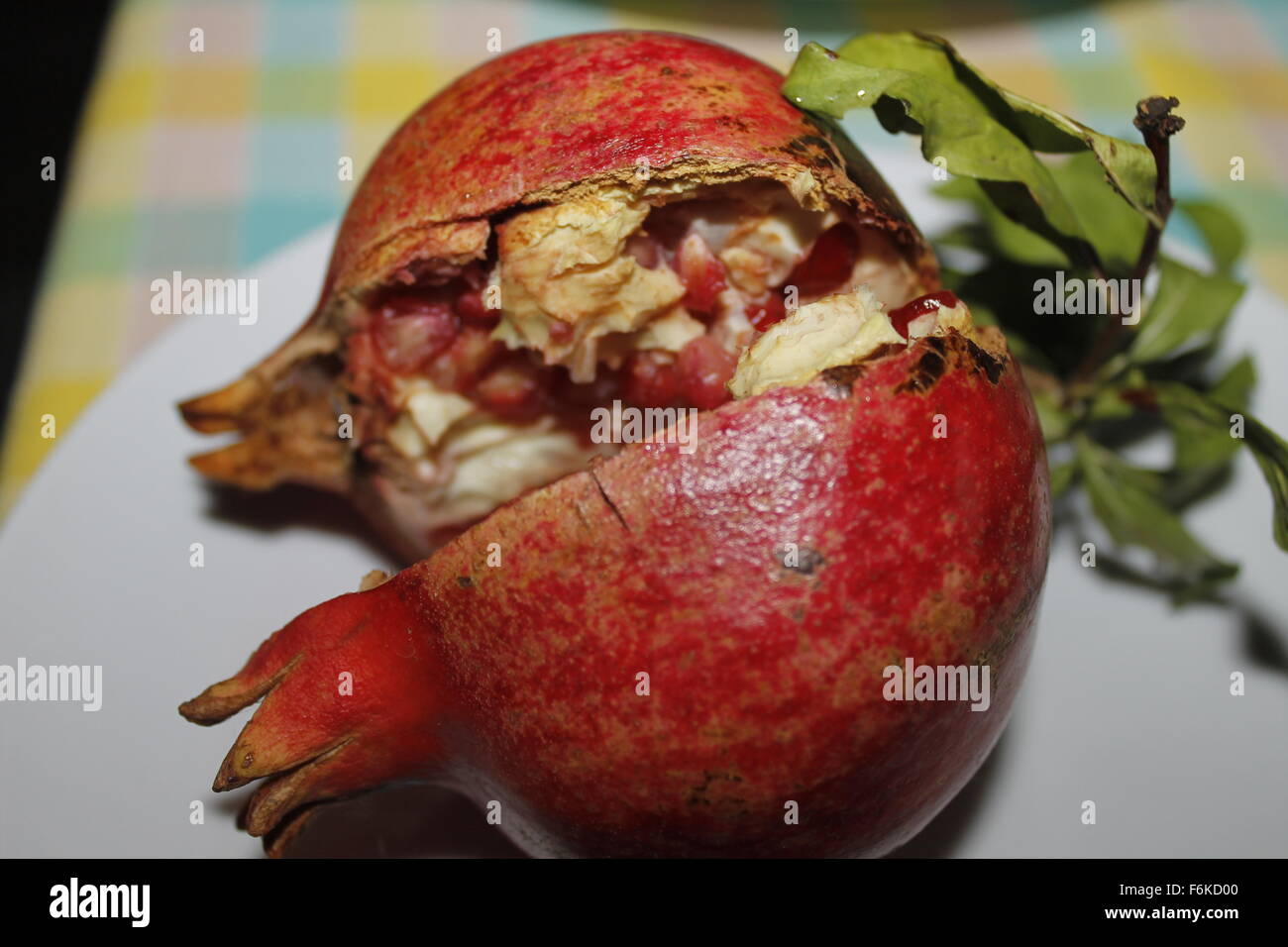 ripe pomegranate on the table Stock Photo - Alamy