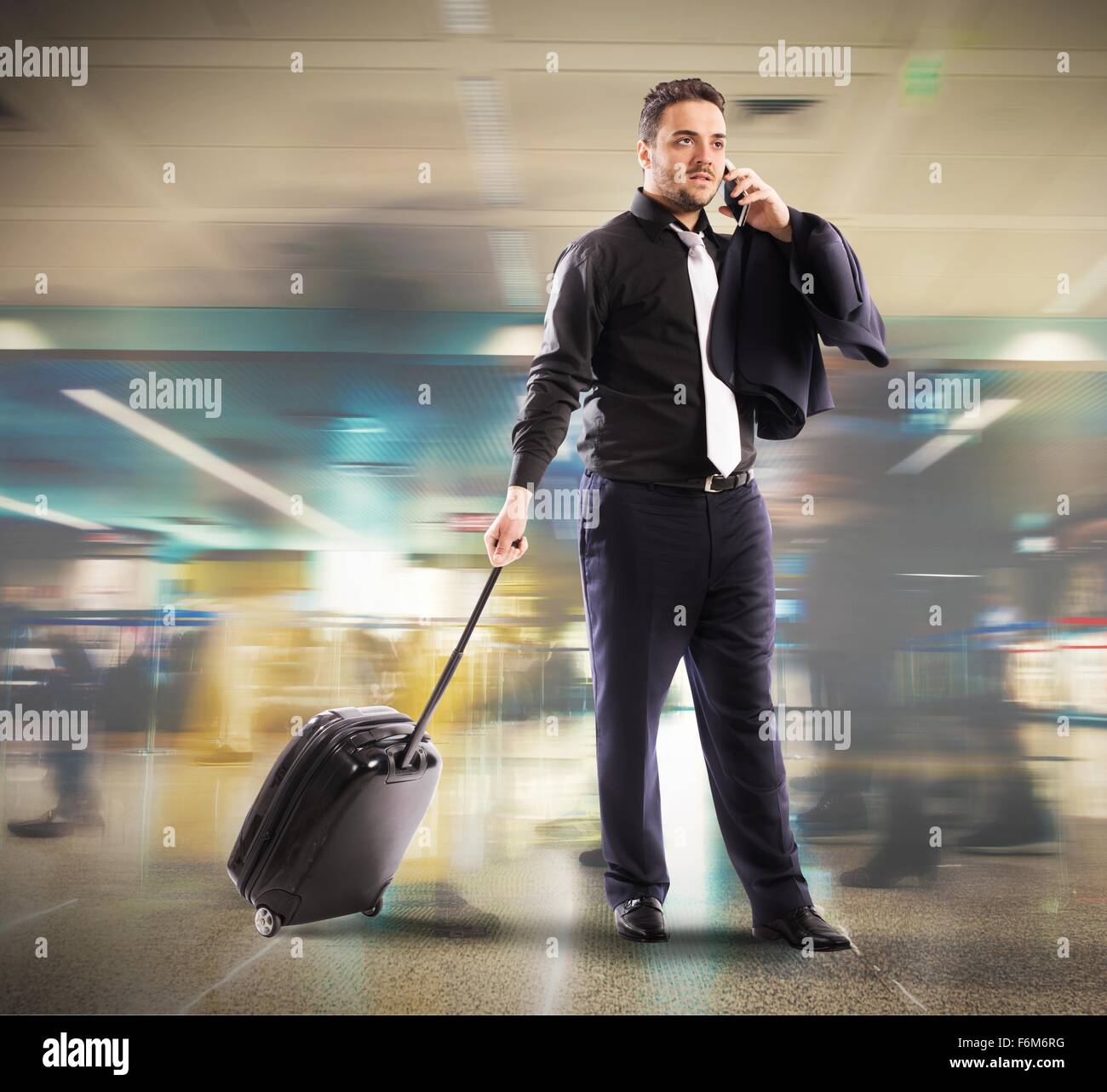 Busy businessman in airport Stock Photo - Alamy