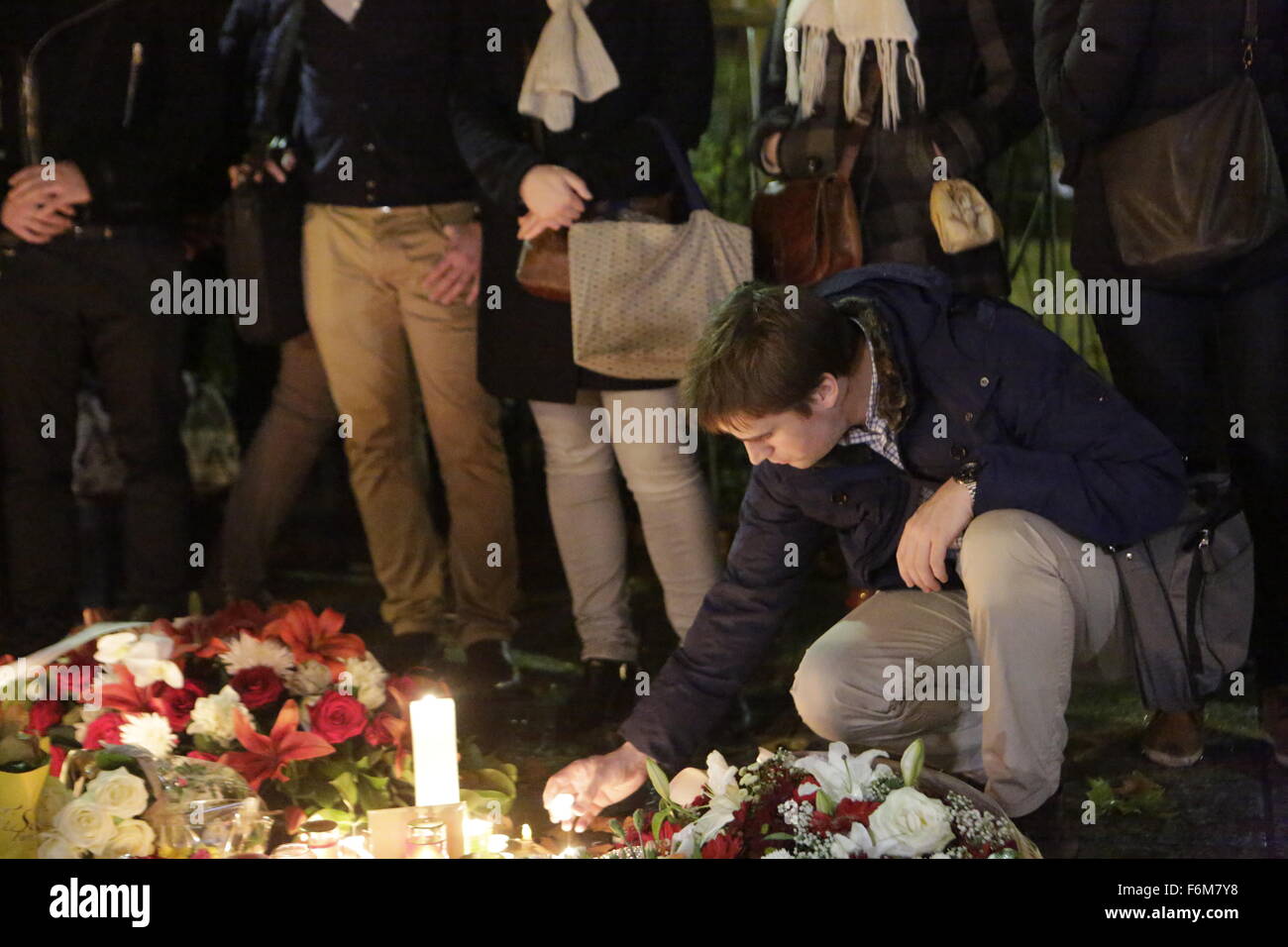 Paris, France. 17th November 2015. A man places a candle at the ...