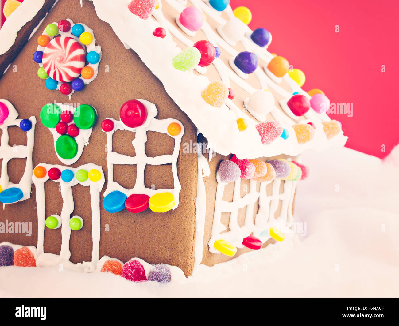 Decorated gingerbread house on red background Stock Photo - Alamy