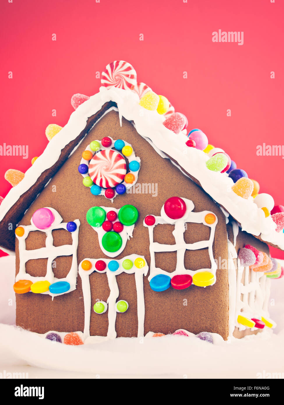 Decorated gingerbread house on red background Stock Photo - Alamy