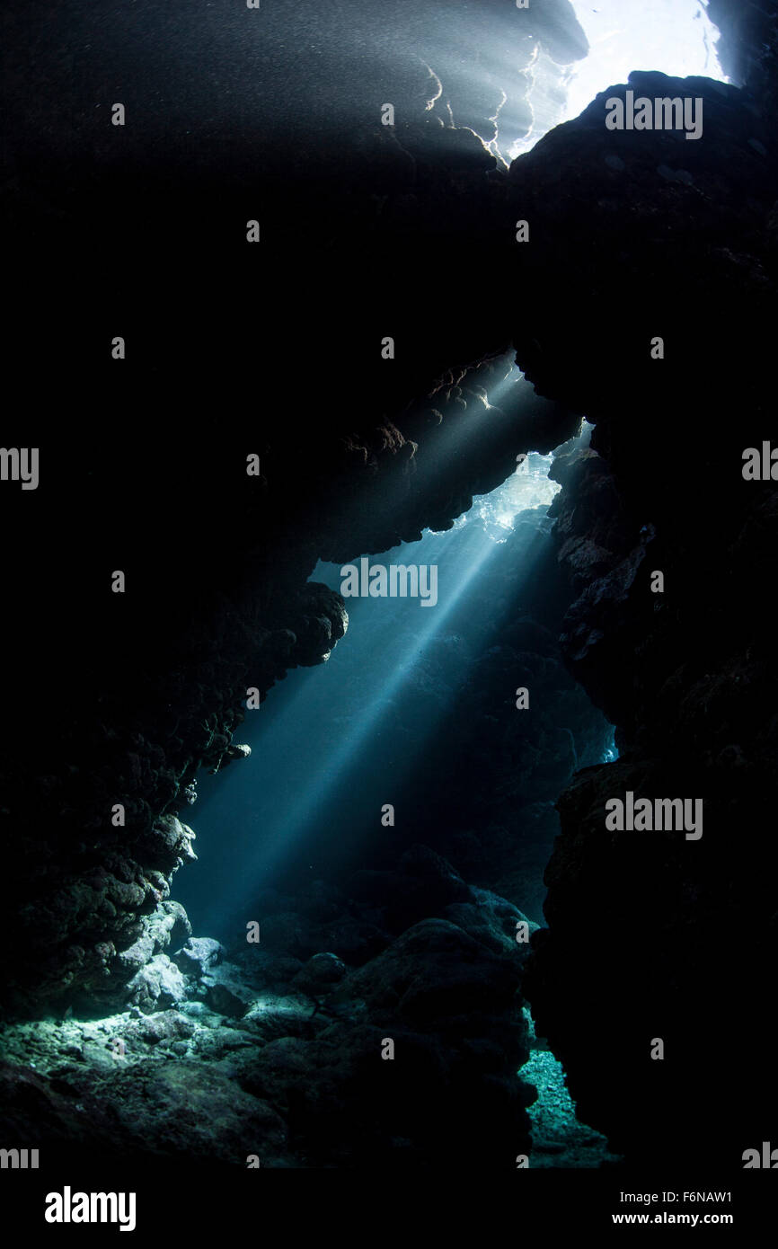 Sunlight descends underwater and into a crevice in a reef in the ...