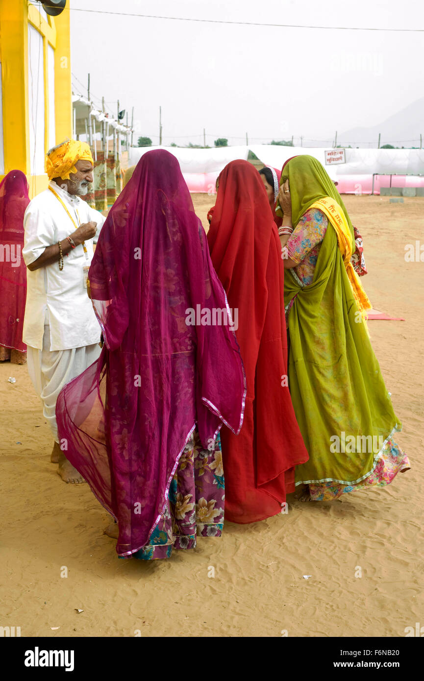 Women talking with priest, pathmeda, godham, rajasthan, india, asia ...