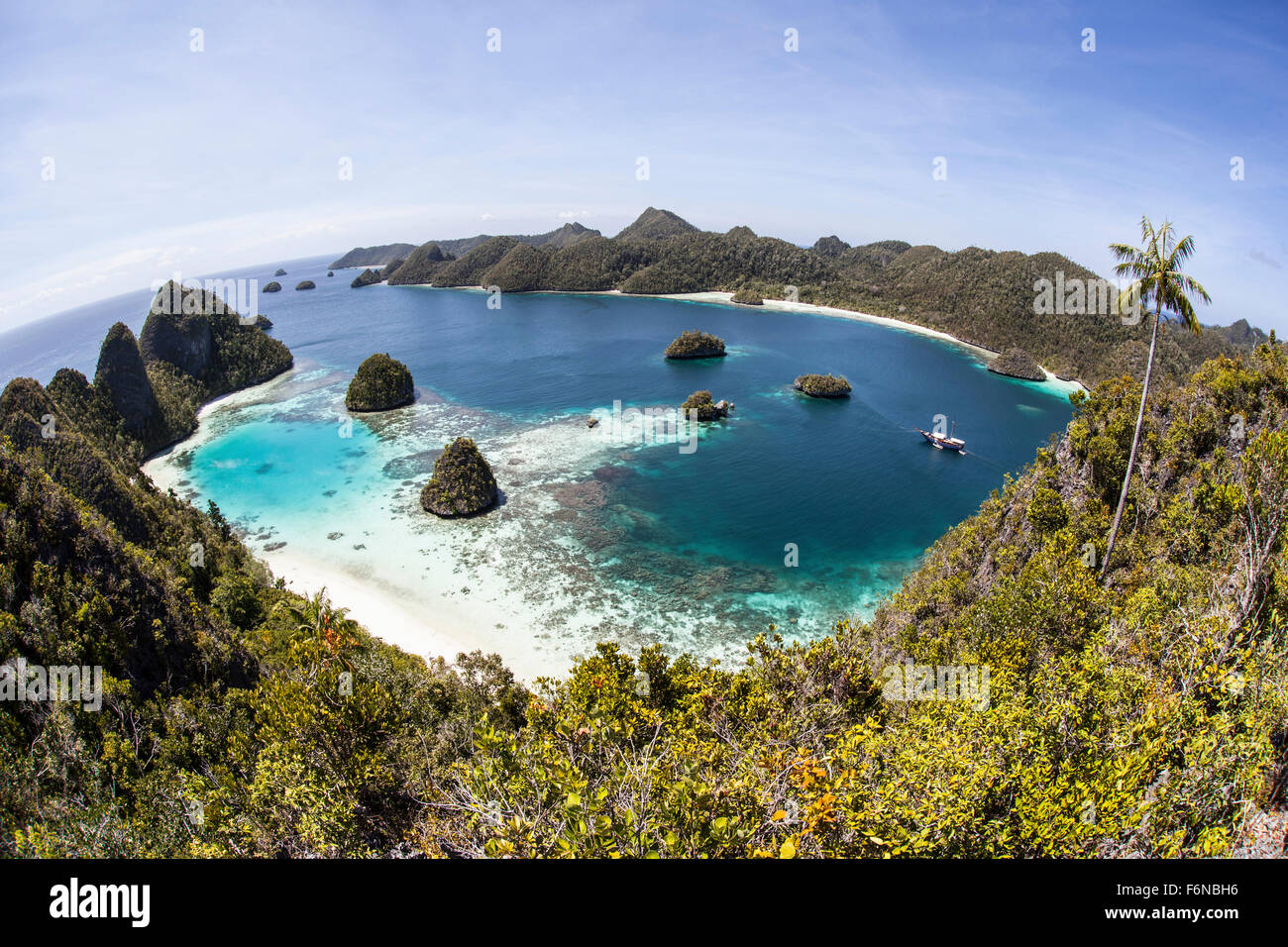 Rugged limestone islands surround a gorgeous lagoon in a remote part of ...