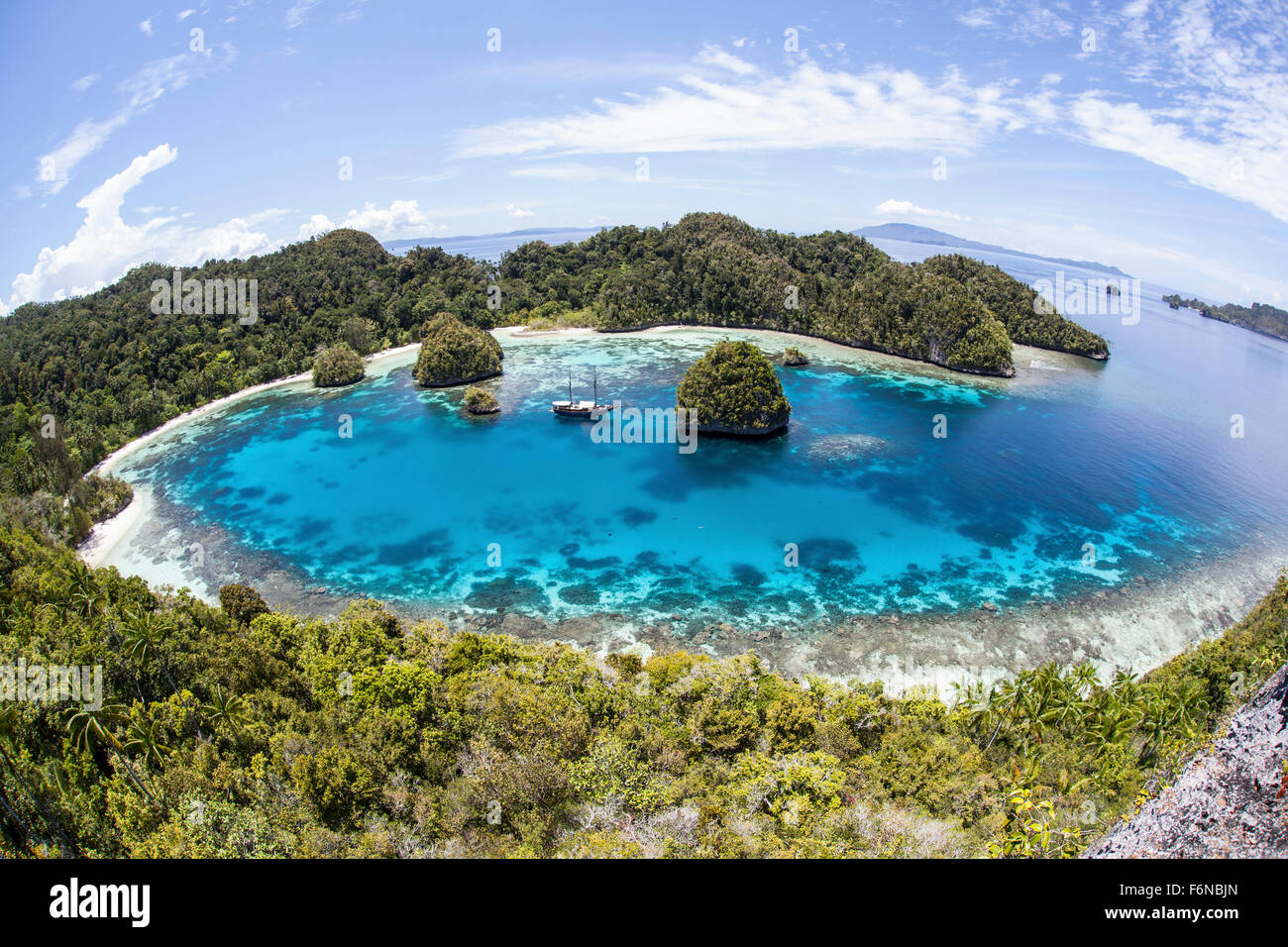 Rugged limestone islands surround a gorgeous lagoon in a remote part of ...