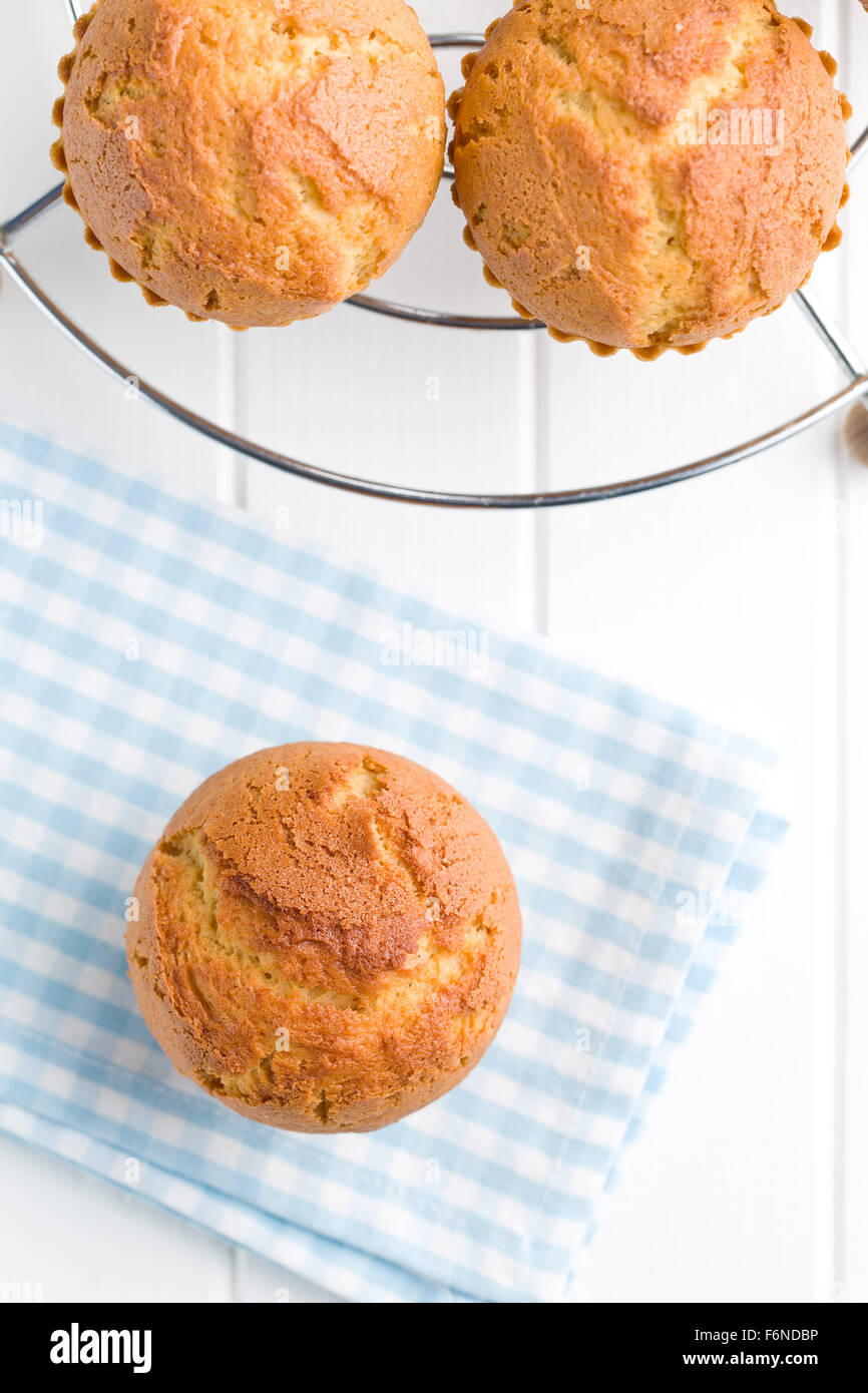 sweet muffins on white kitchen table Stock Photo - Alamy