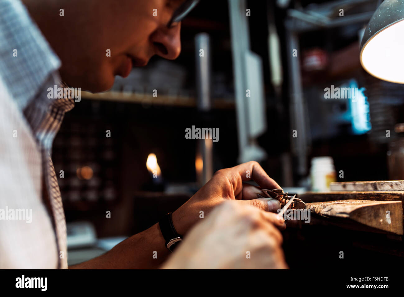 Goldsmith working and creating jewelry Stock Photo - Alamy