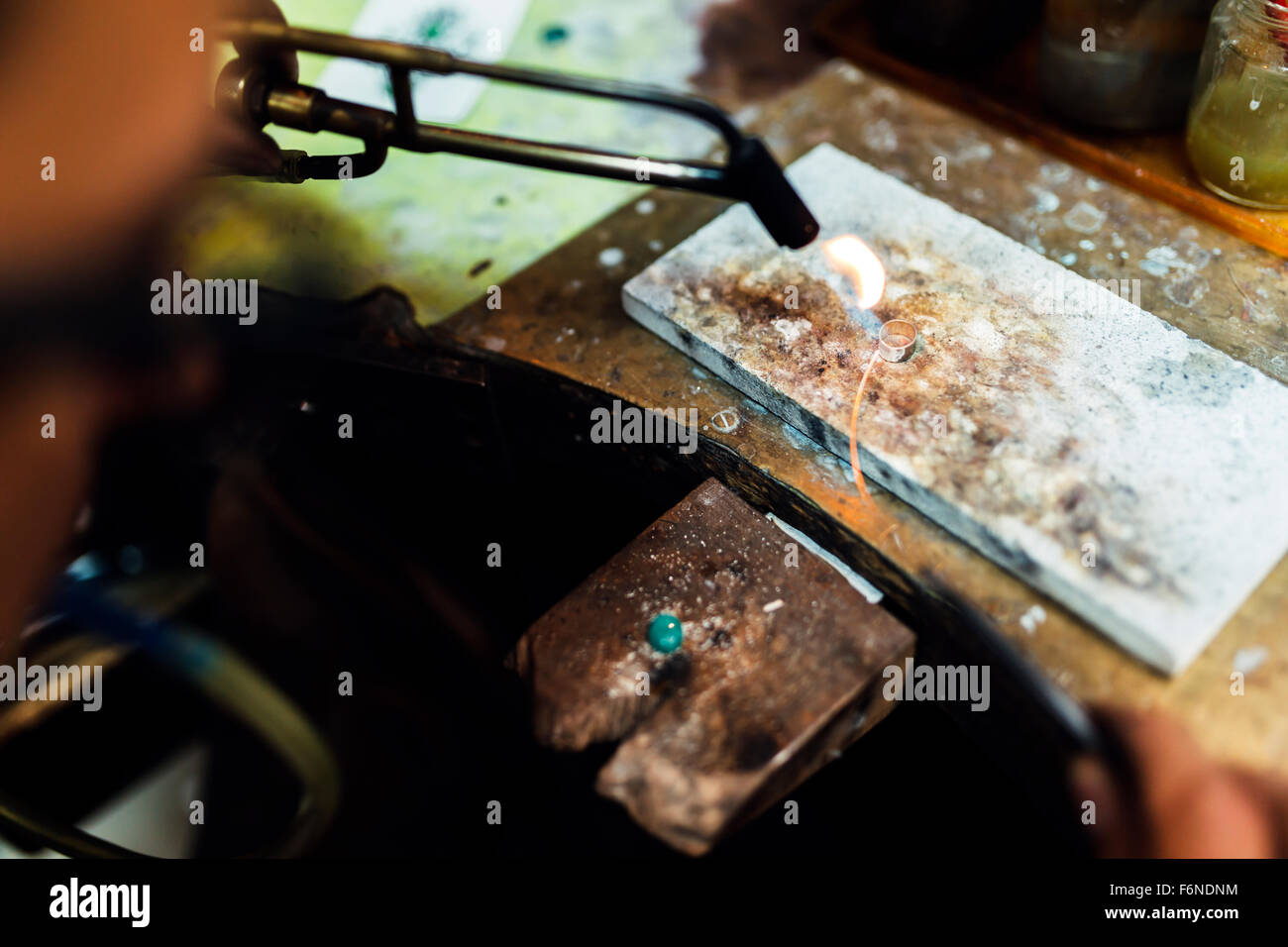 Jeweler crafting jewelry on his workbench Stock Photo - Alamy