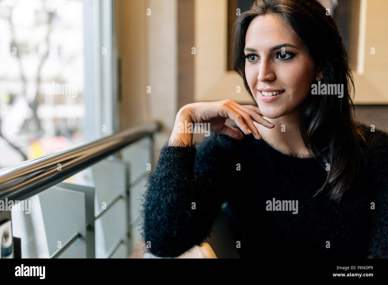 Pensive beautiful brunette looking out the window Stock Photo - Alamy