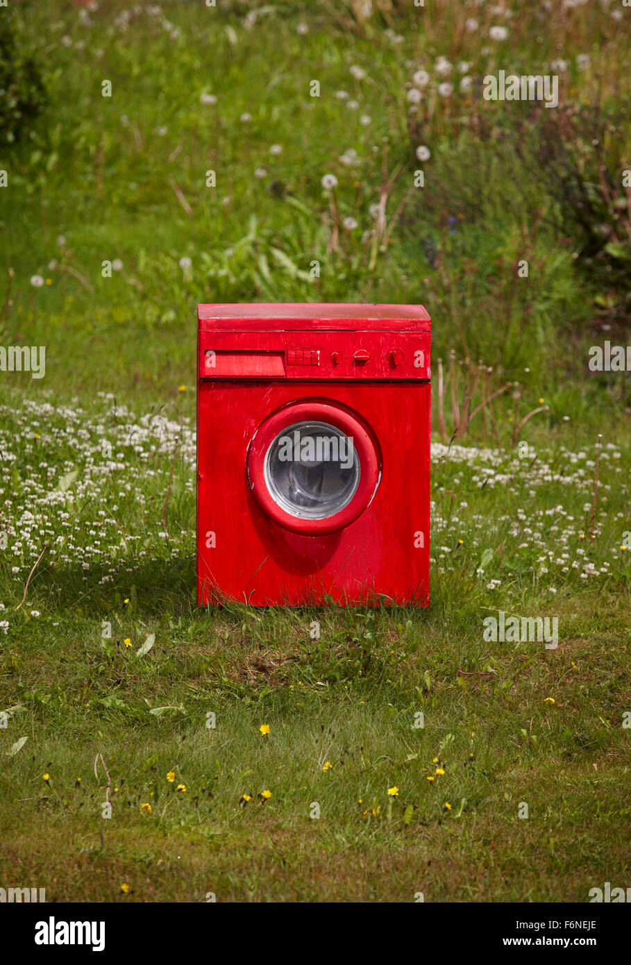 Red painted washing machine on the ground Stock Photo - Alamy