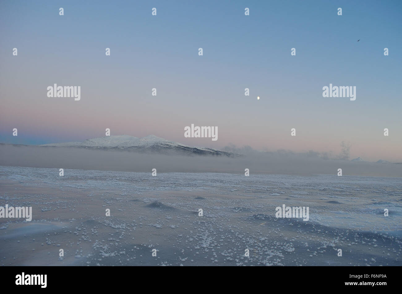 long icy sea with thick ice fog and mist with colorful dawn sky on very ...