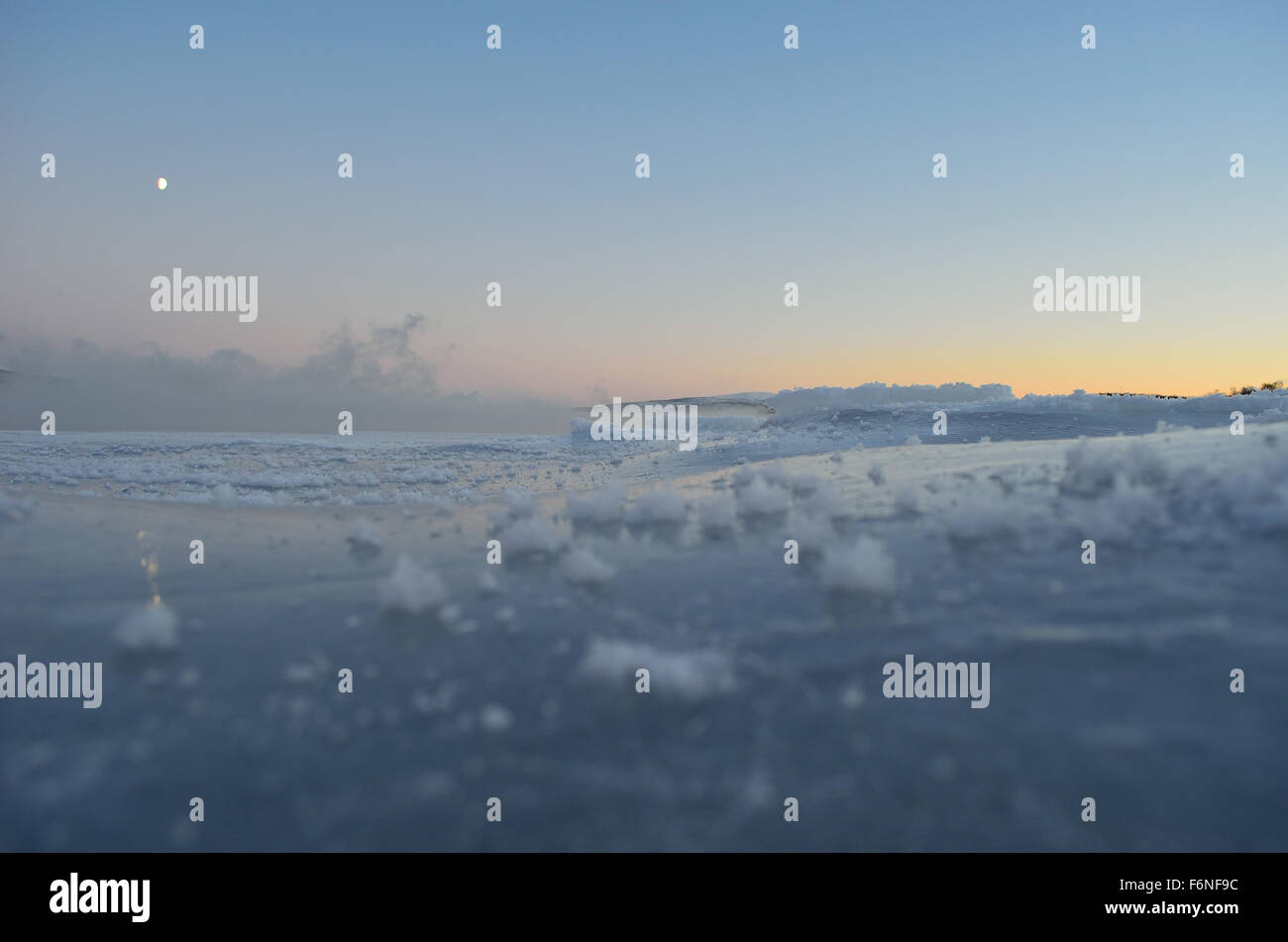 long icy sea with thick ice fog and mist with colorful dawn sky on very ...