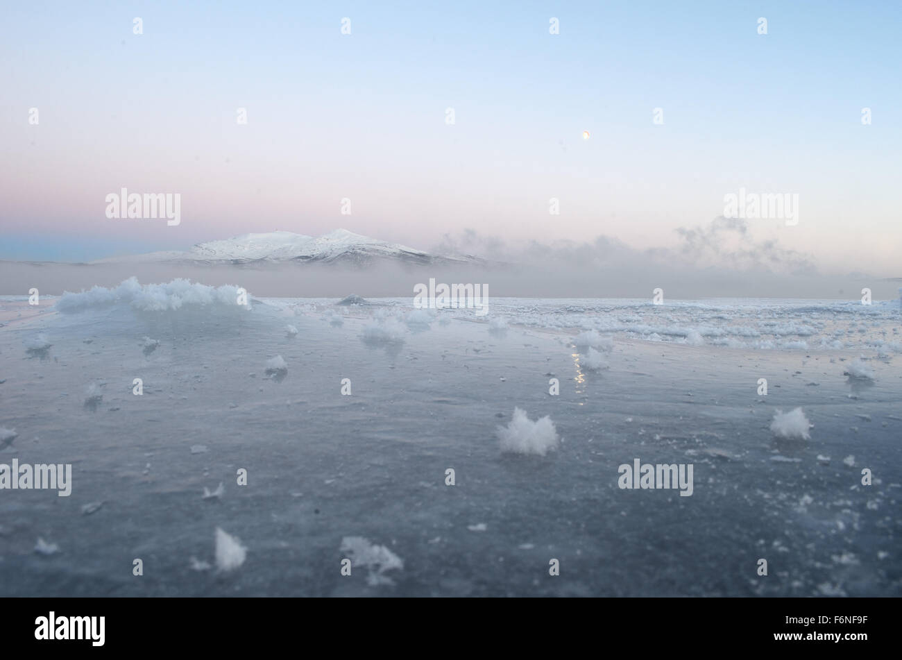 long icy sea with thick ice fog and mist with colorful dawn sky on very ...