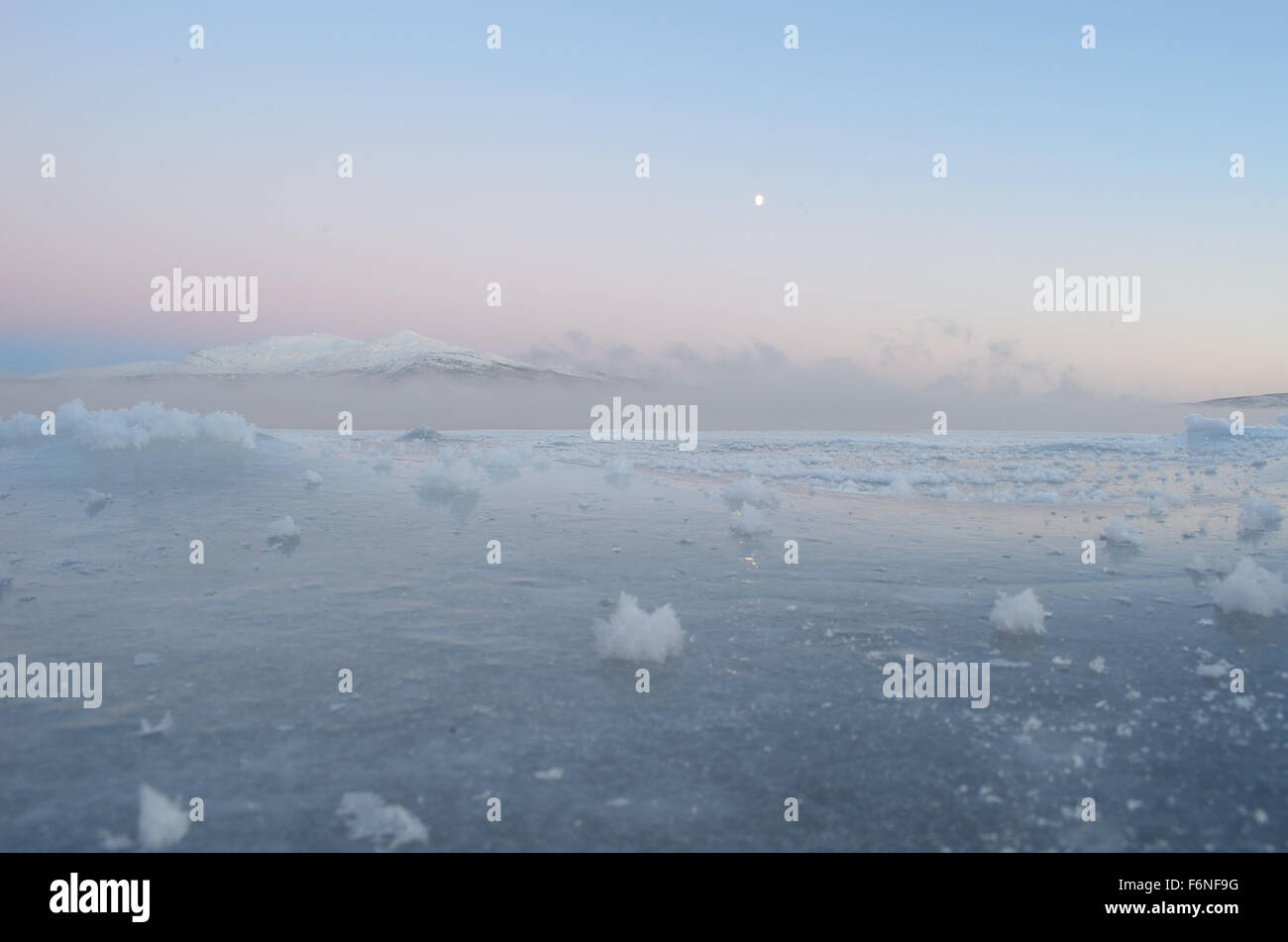 long icy sea with thick ice fog and mist with colorful dawn sky on very ...