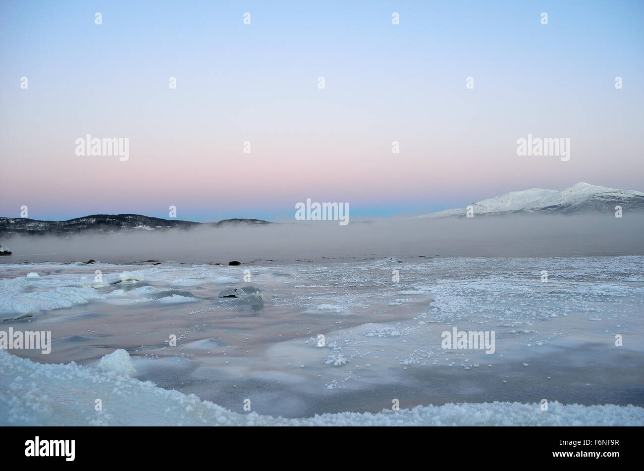 long icy sea with thick ice fog and mist with colorful dawn sky on very ...