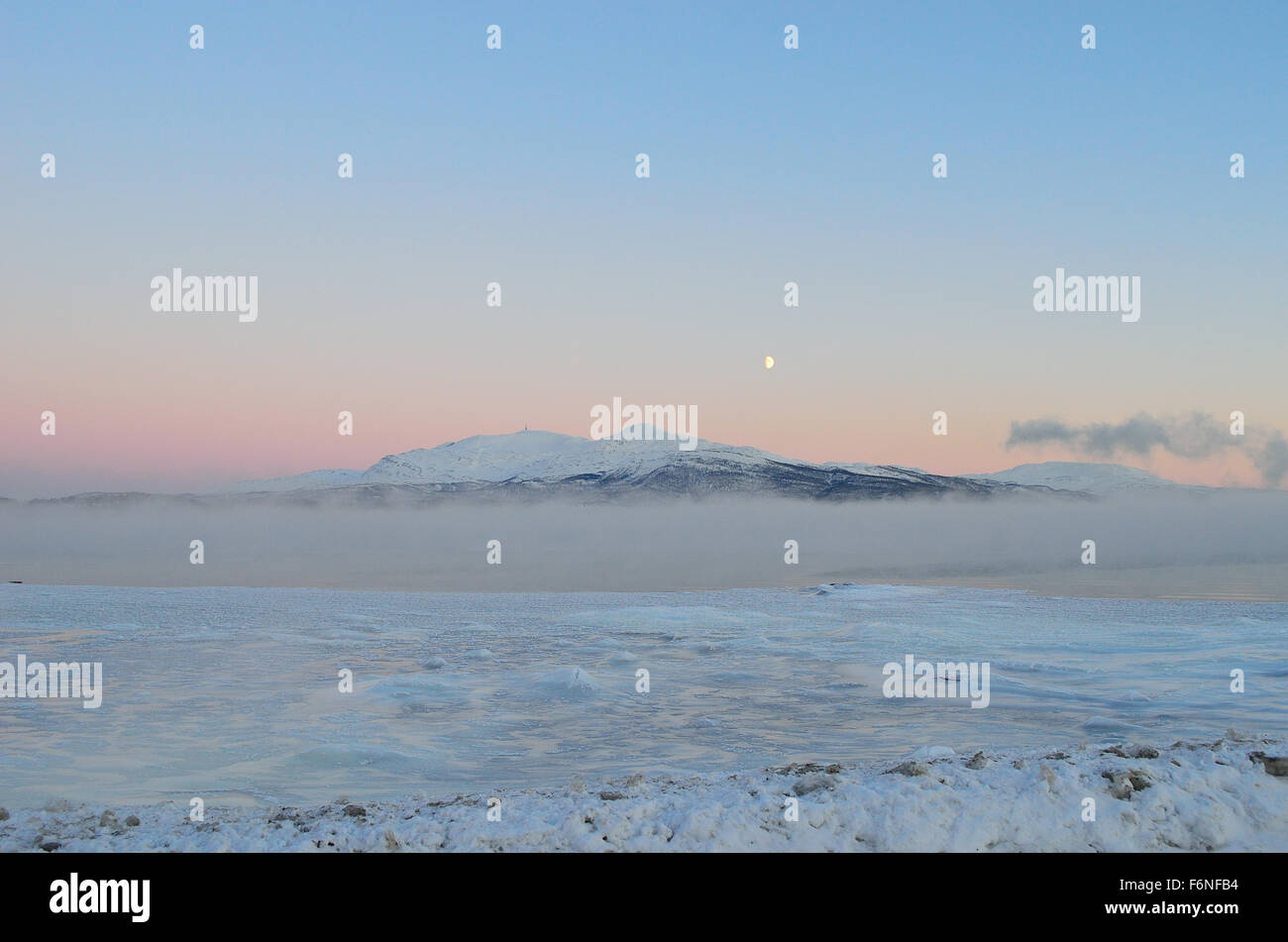 heavy eerie sea frost mist and fog over icy sea landscape with colorful ...