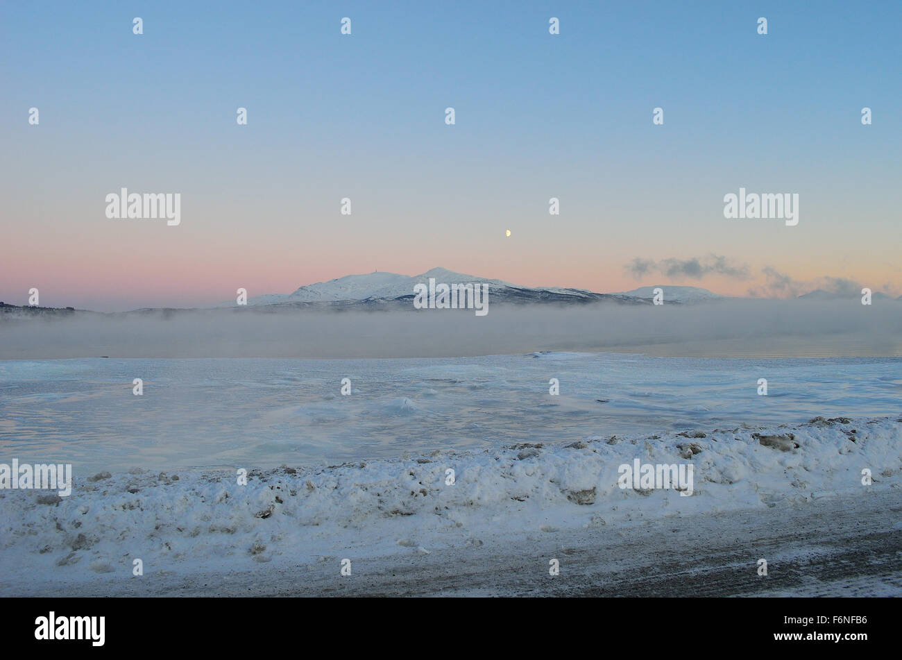 heavy eerie sea frost mist and fog over icy sea landscape with colorful ...
