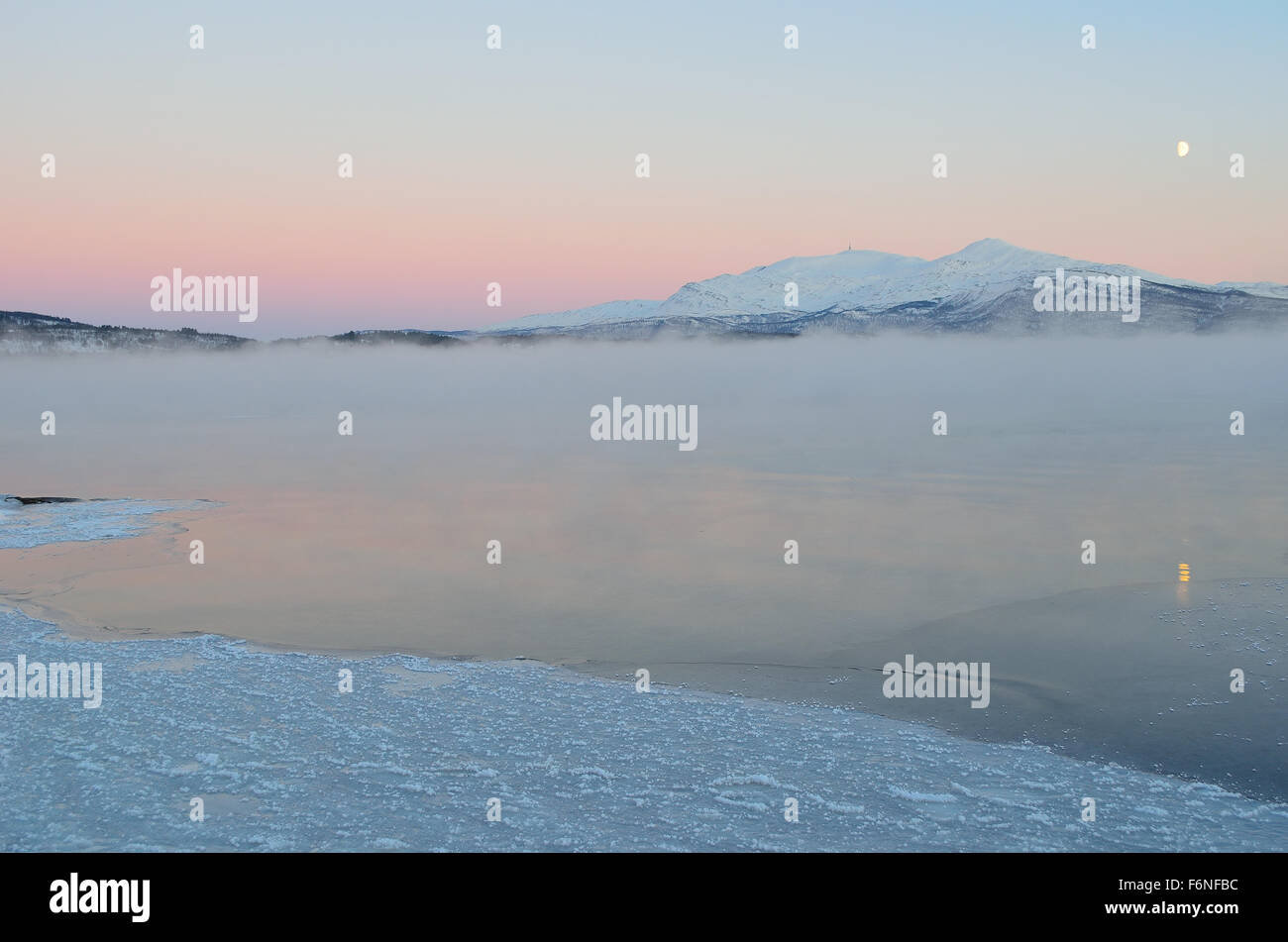 heavy eerie sea frost mist and fog over icy sea landscape with colorful ...