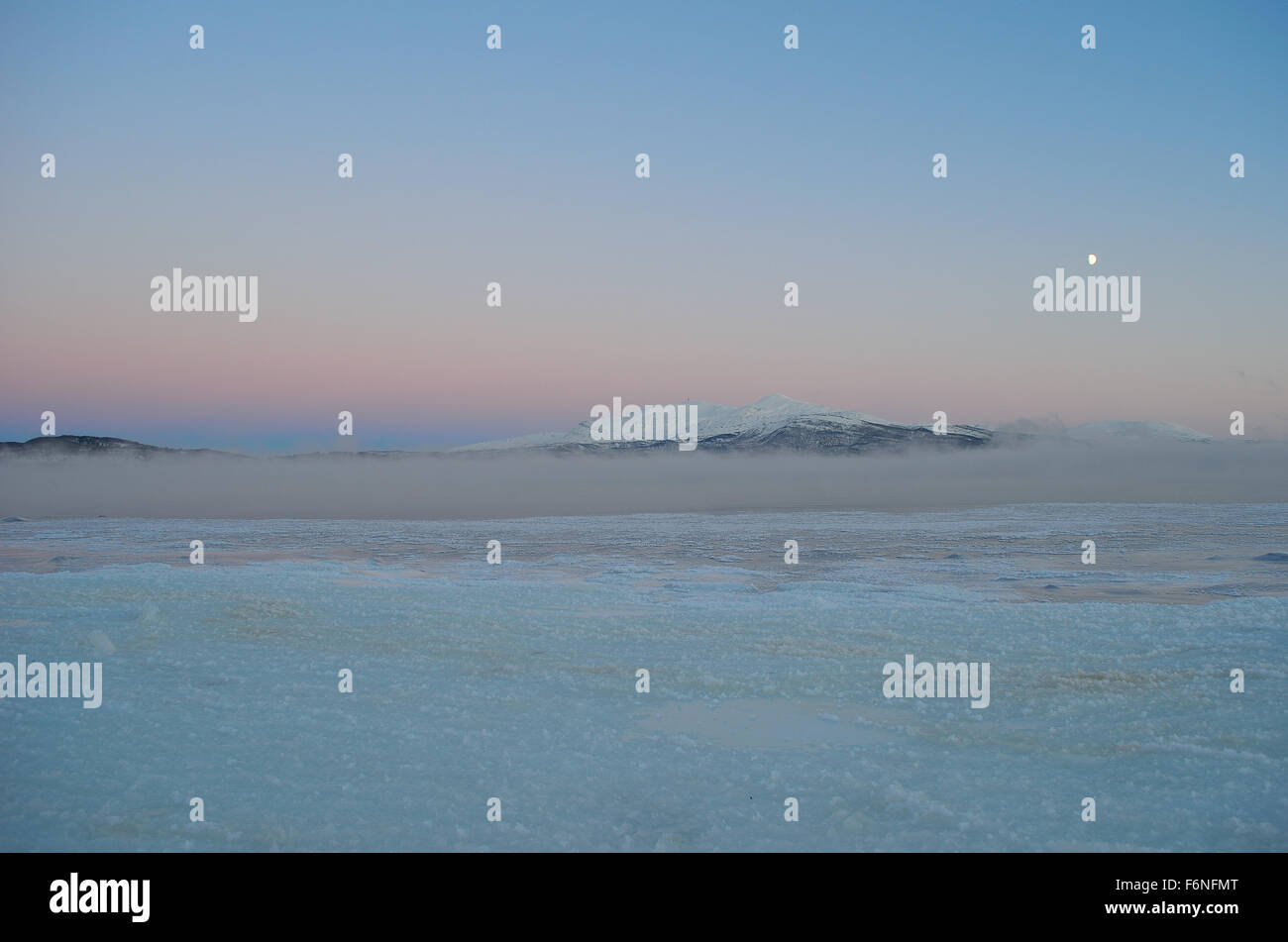 heavy eerie sea frost mist and fog over icy sea landscape with colorful ...