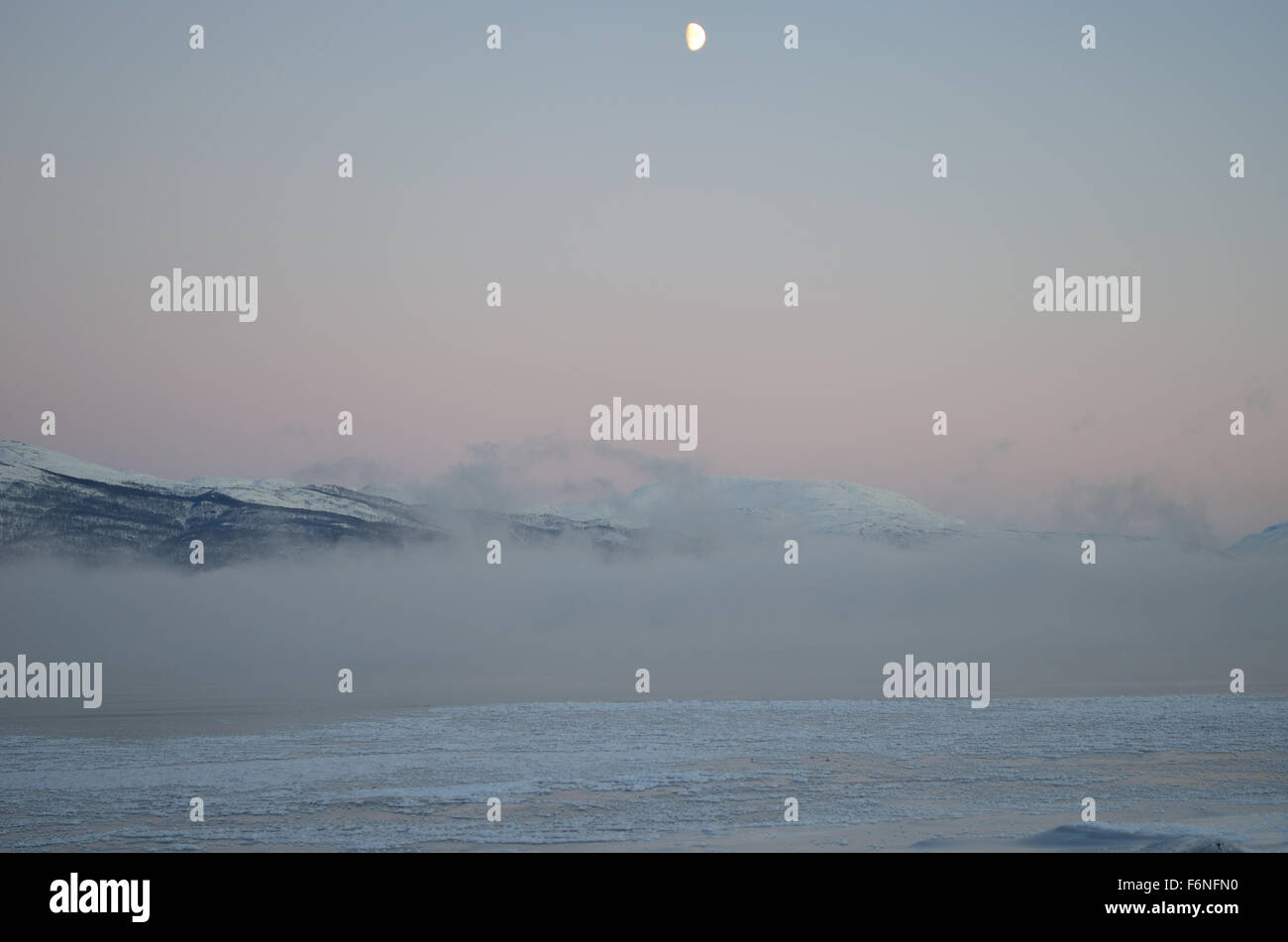 heavy eerie sea frost mist and fog over icy sea landscape with colorful ...