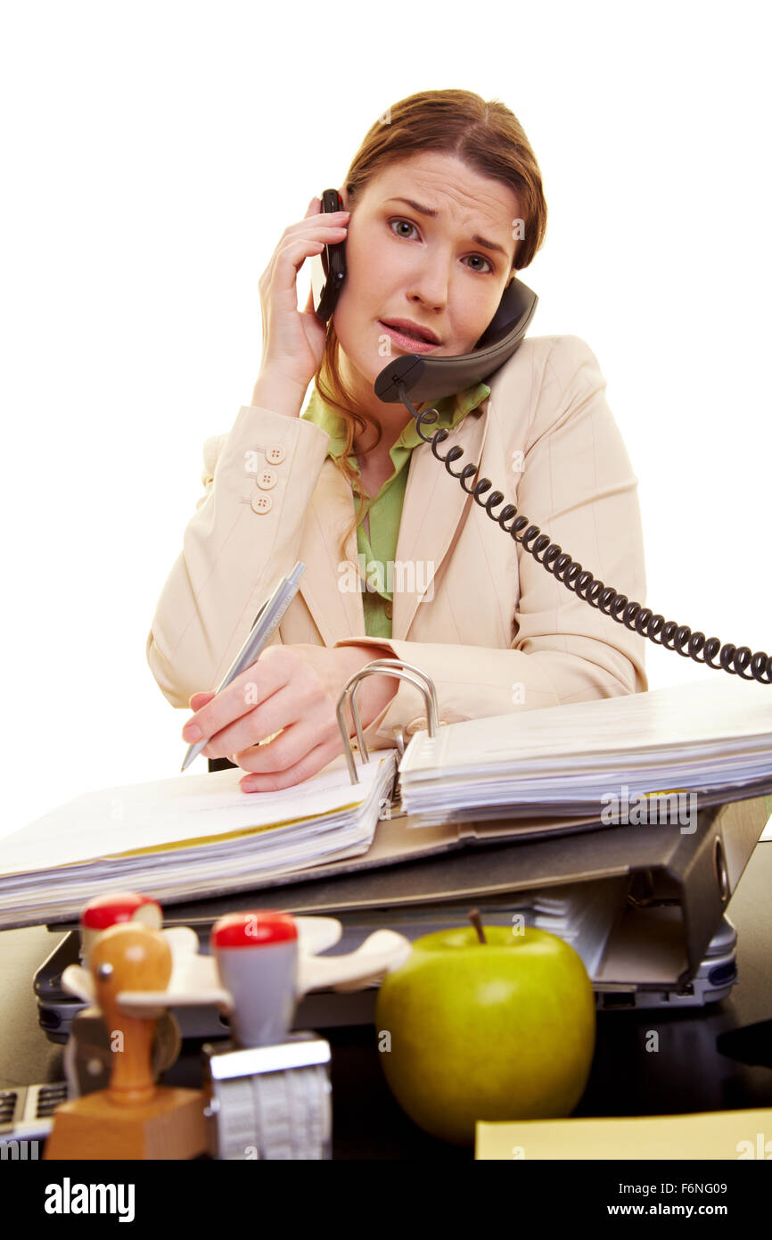 Businesswoman at her desk on the phone taking notes Stock Photo - Alamy