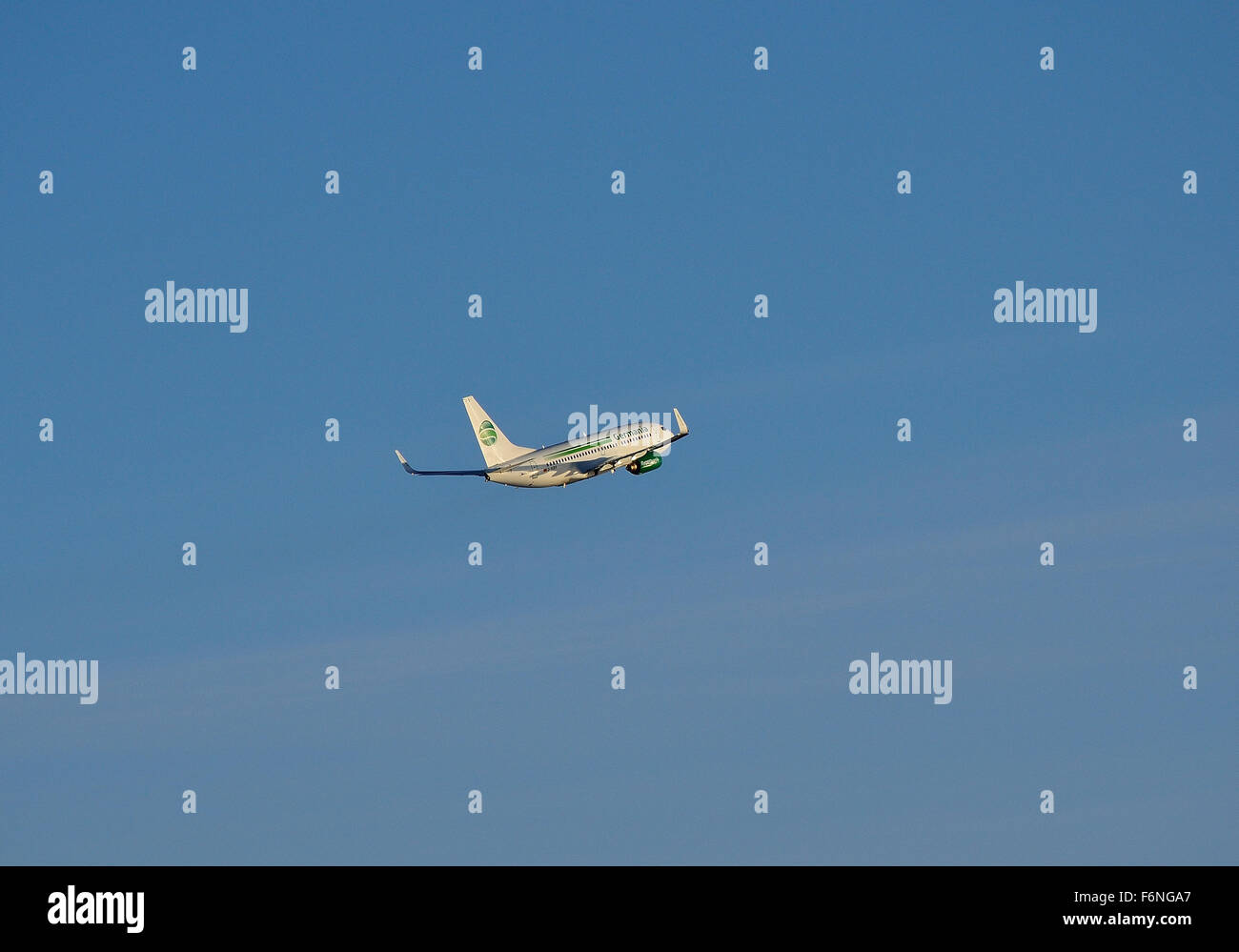 passenger airplane climbing on blue winter sky Stock Photo - Alamy