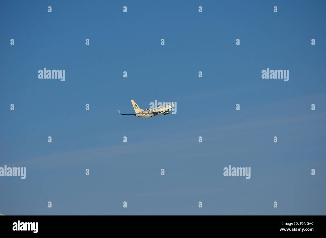passenger airplane climbing on blue winter sky Stock Photo - Alamy