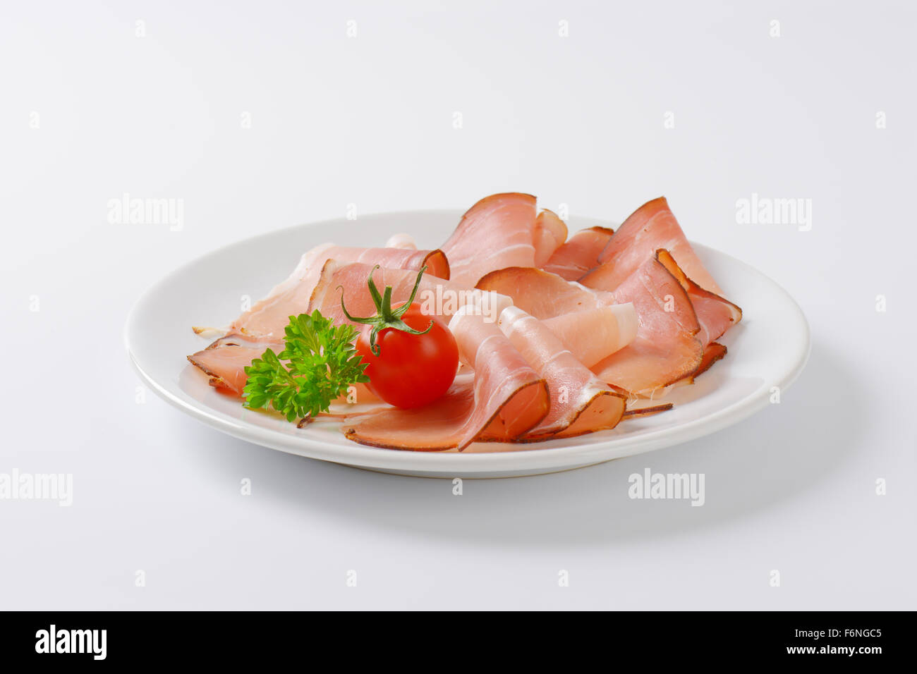 plate of dried pork ham on white background Stock Photo - Alamy