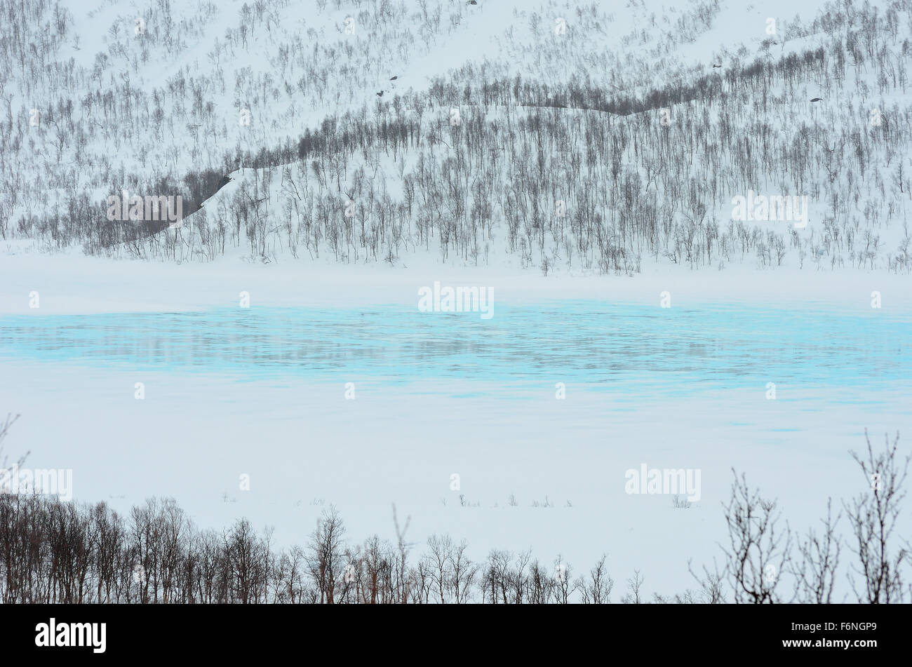 vibrant clear blue ice under mountain in winter landscape Stock Photo ...