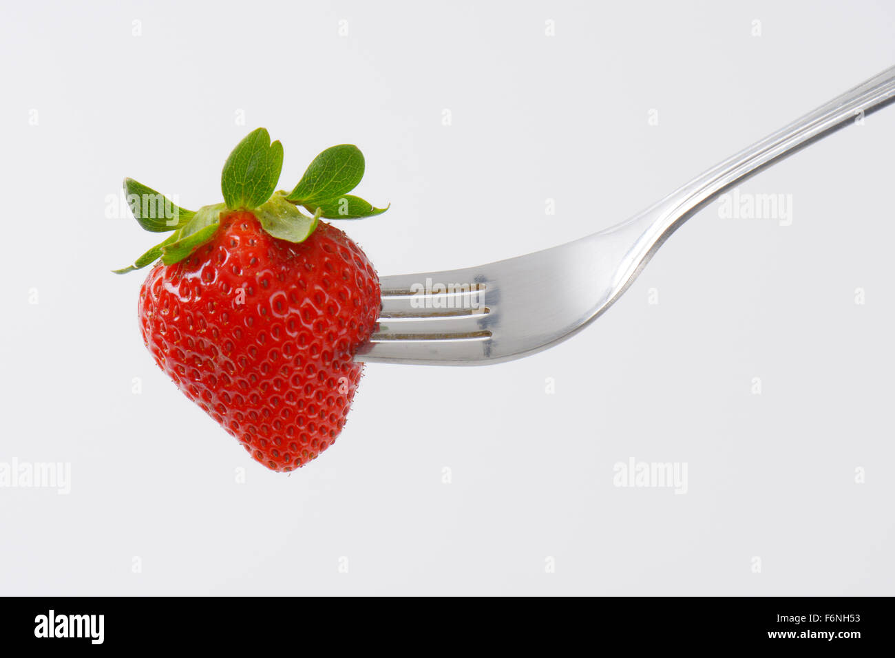 close up of red strawberry on silver fork Stock Photo - Alamy
