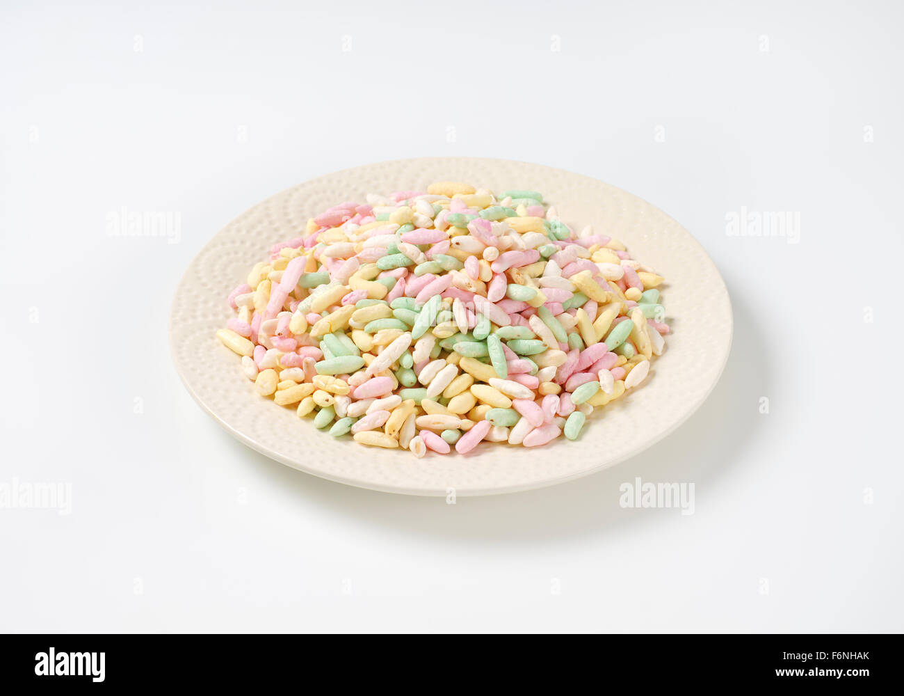 plate of colorful puffed rice on white background Stock Photo - Alamy